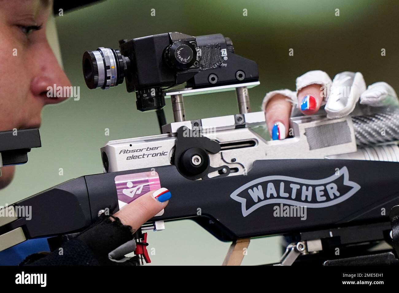 Alison Marie Weisz, of the United States, loads her rifle wearing red ...