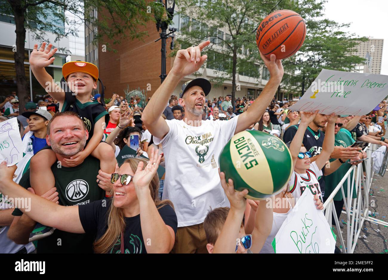 Fans yell as the bus carrying Milwaukee Bucks' Giannis Antetokounmpo ...