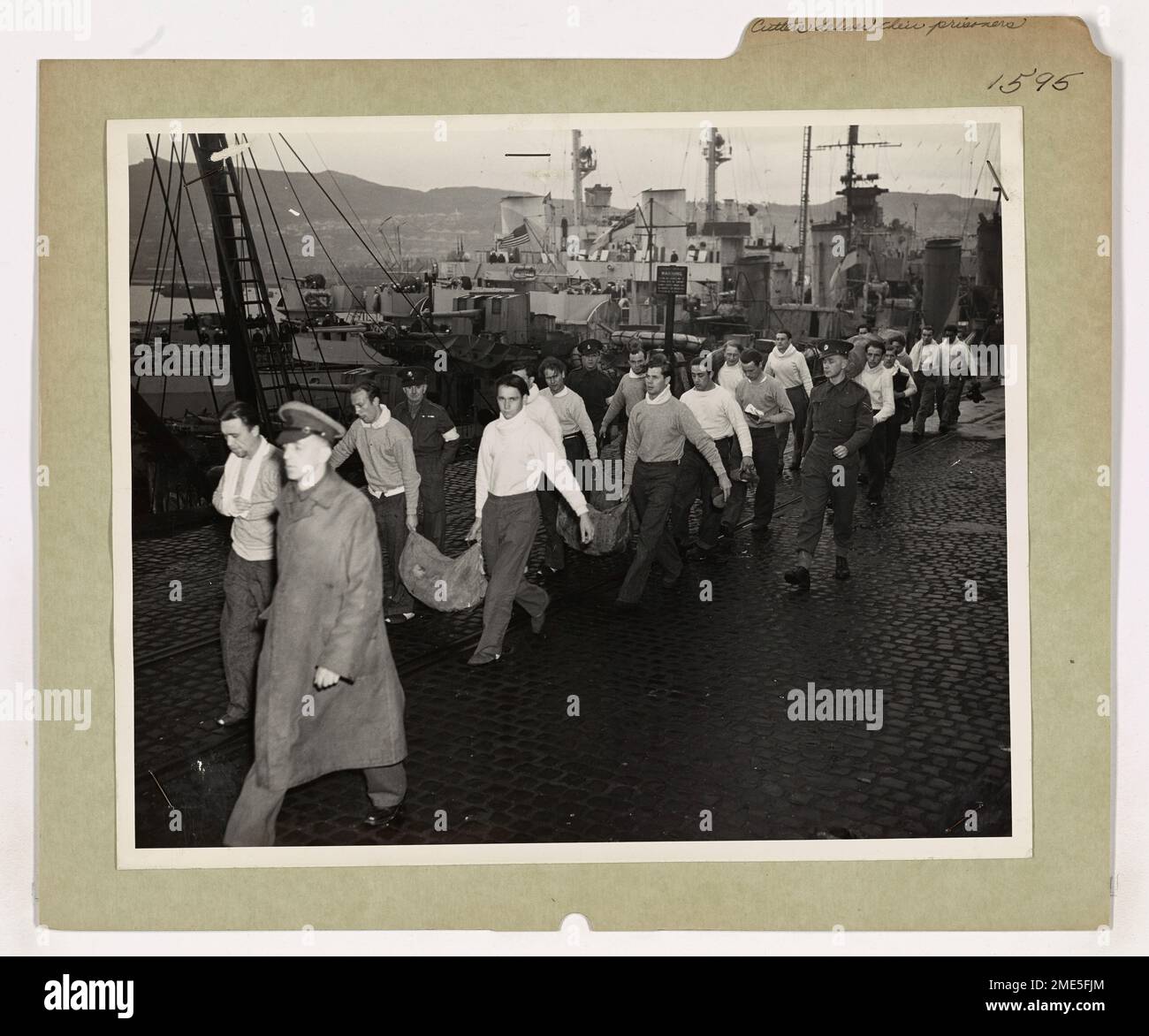 Captured German sailors are transferred to a prison camp by British ...