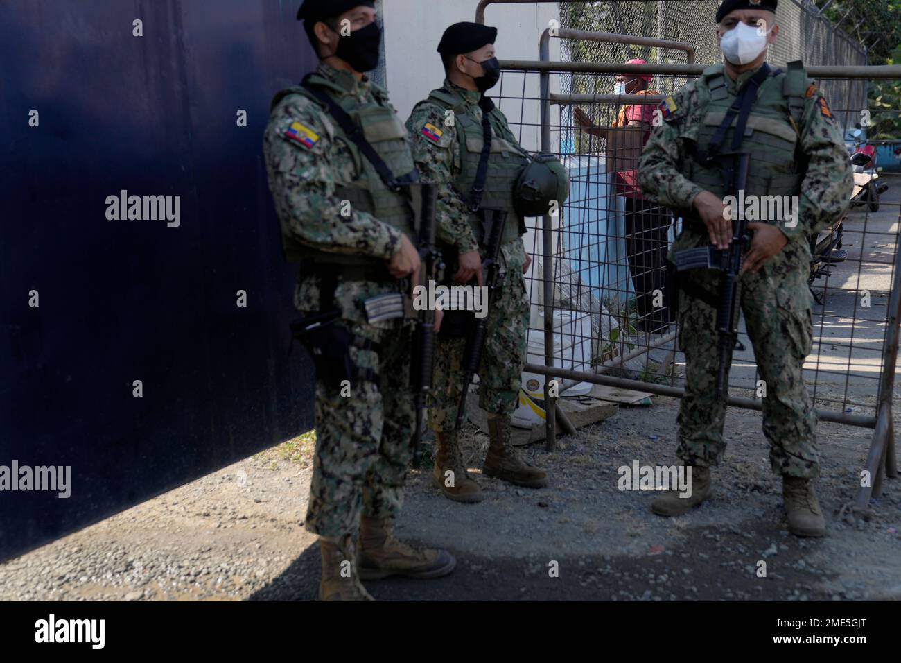 A resident looks through a gate surrounding the Litoral Penitentiary as ...