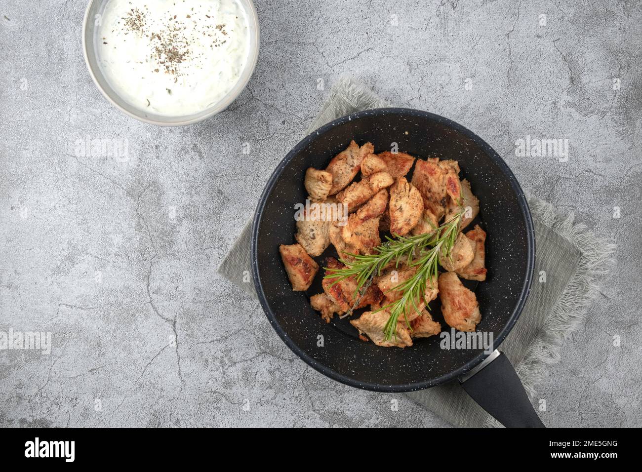 Greek gyros in a frying pan on a gray background Stock Photo - Alamy