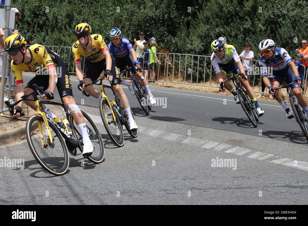 Riders negotiating the final turn prior to the finish line in stage 3 ...