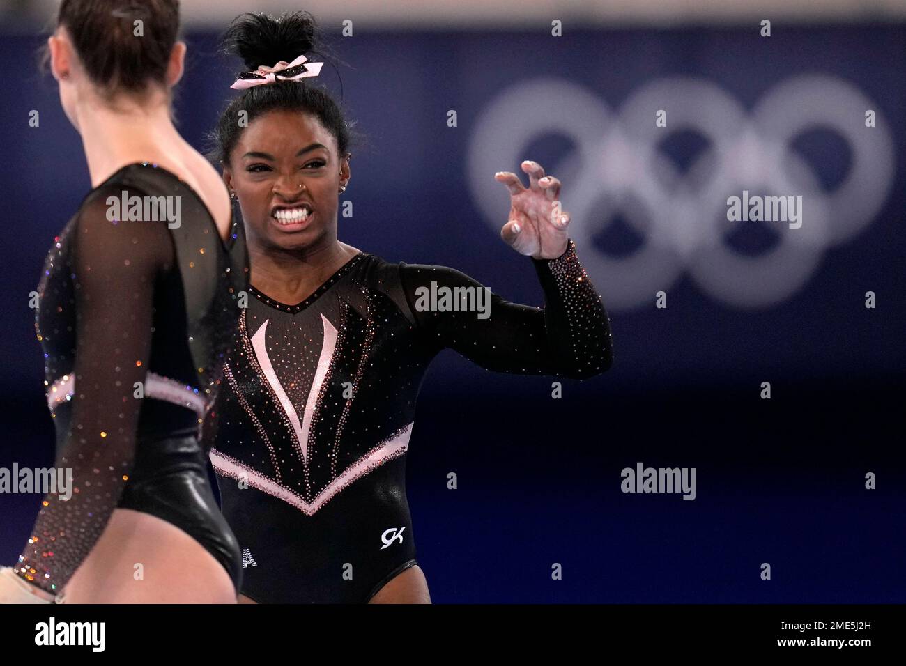 Simone Biles, of the United States, jokes with teammates as she trains ...