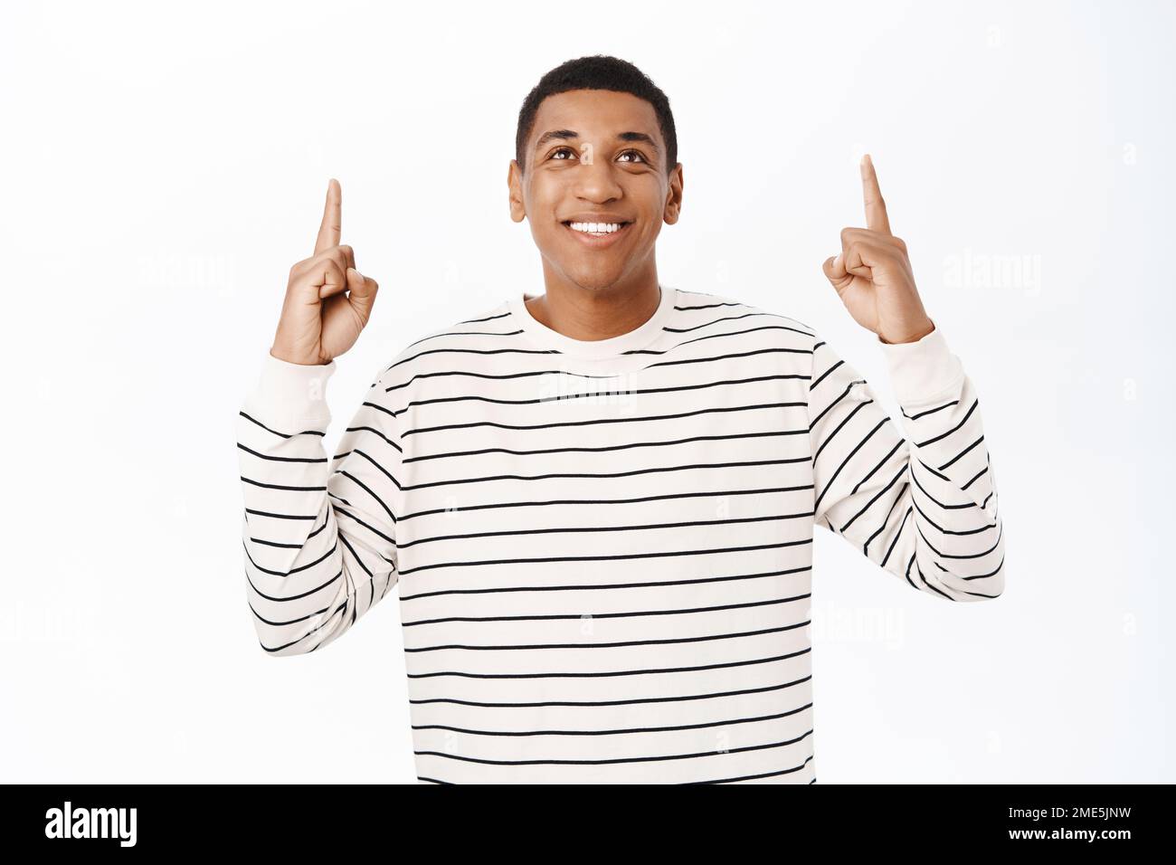 Happy african american man pointing finger up and smiling, showing ...