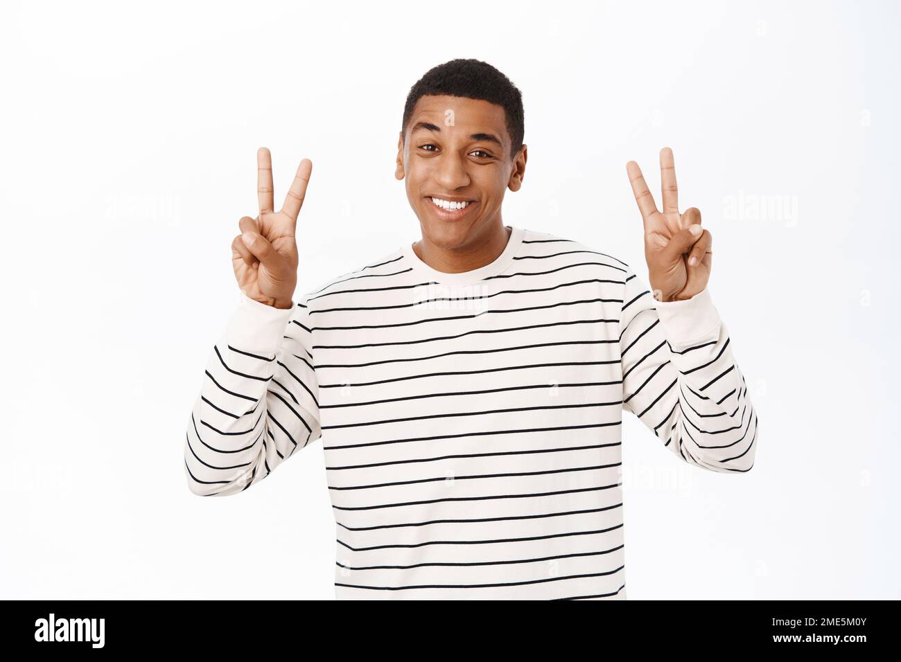 Portrait of handsome african american guy, showing peace, v-sign and ...