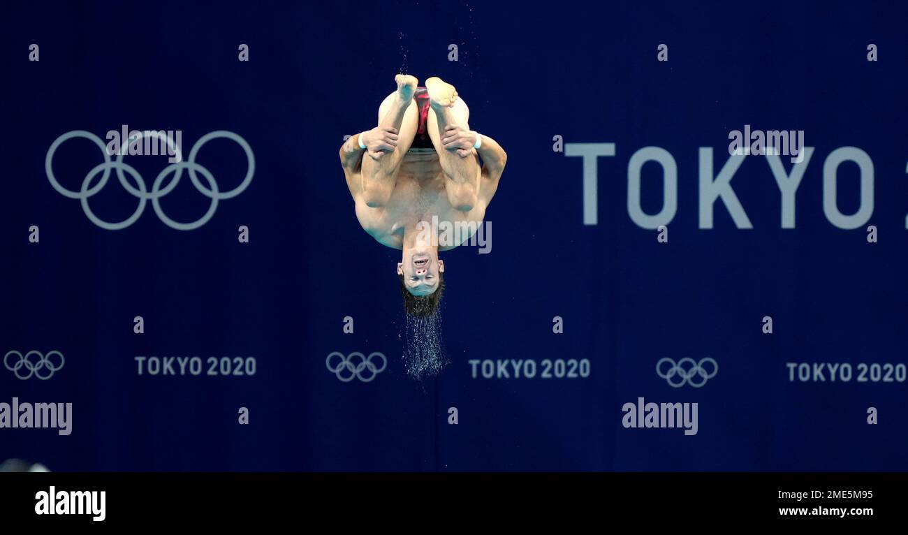 An athletes jumps in front of the Olympic Rings during a diving ...