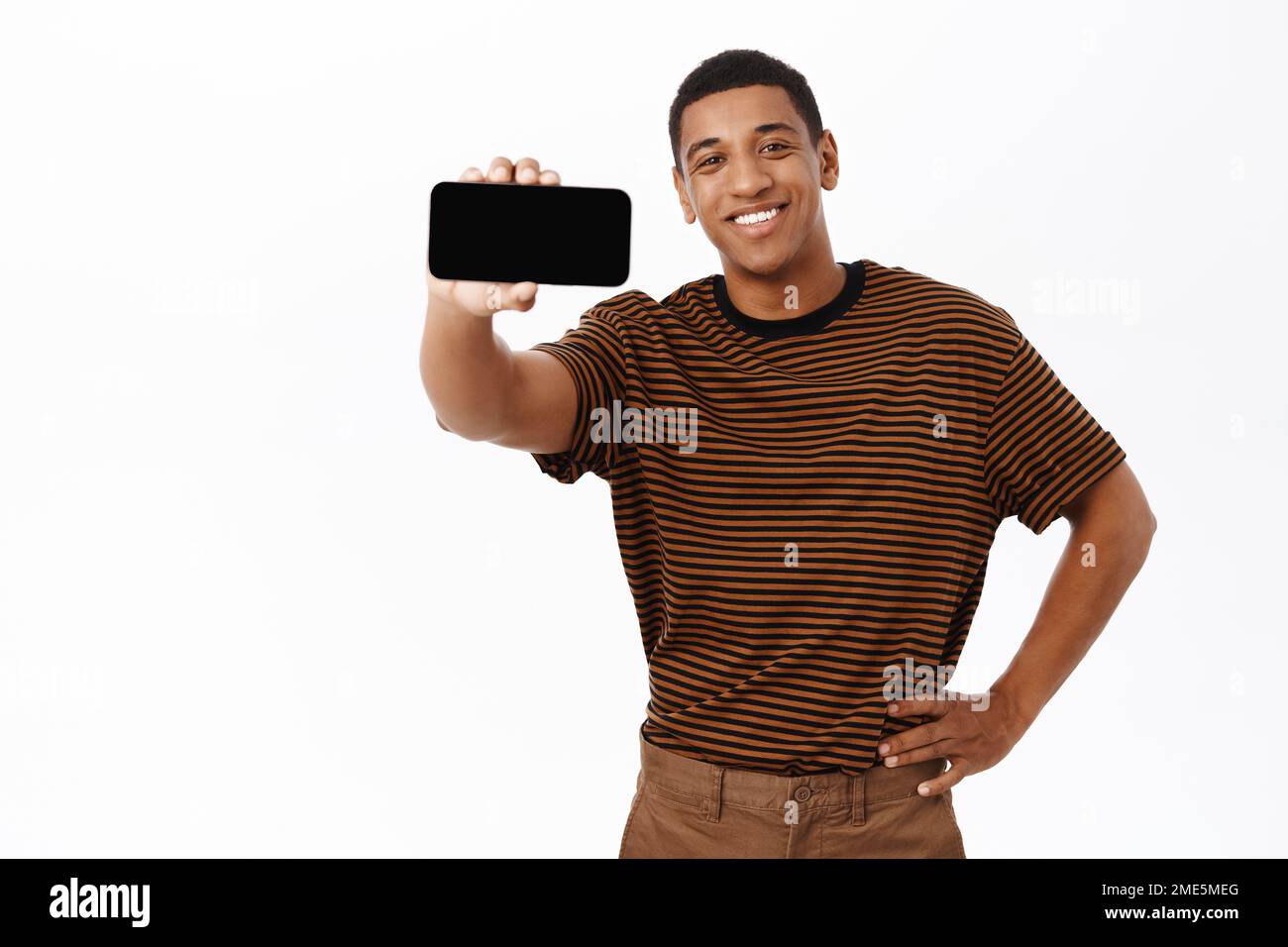 Happy smiling man shows mobile phone screen, produly demonstrating ...
