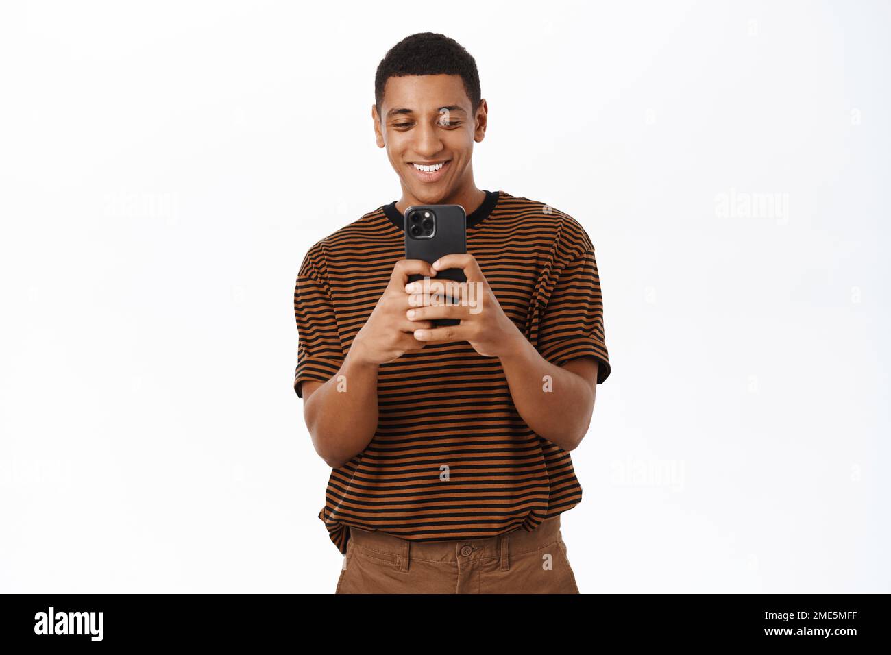 Smiling African american man taking picture, recording video on ...