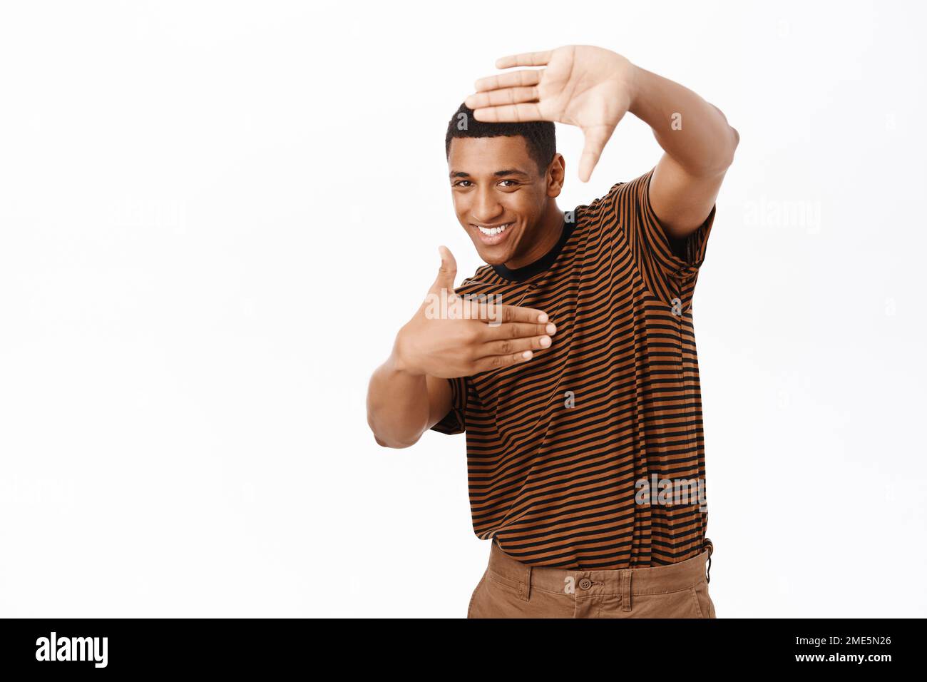 Image of enthusiastic african american man taking picture, capture ...