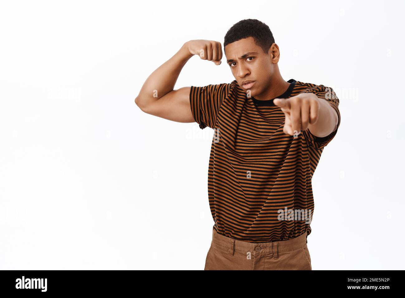 Sport and gym concept. Strong African american man flex biceps, shows ...