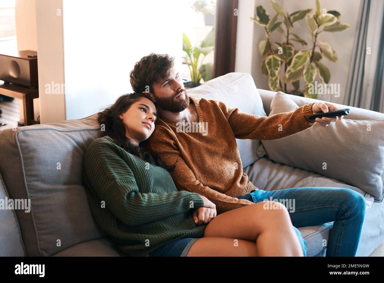 Sometimes love is the comfort of familiarity. a young couple relaxing ...