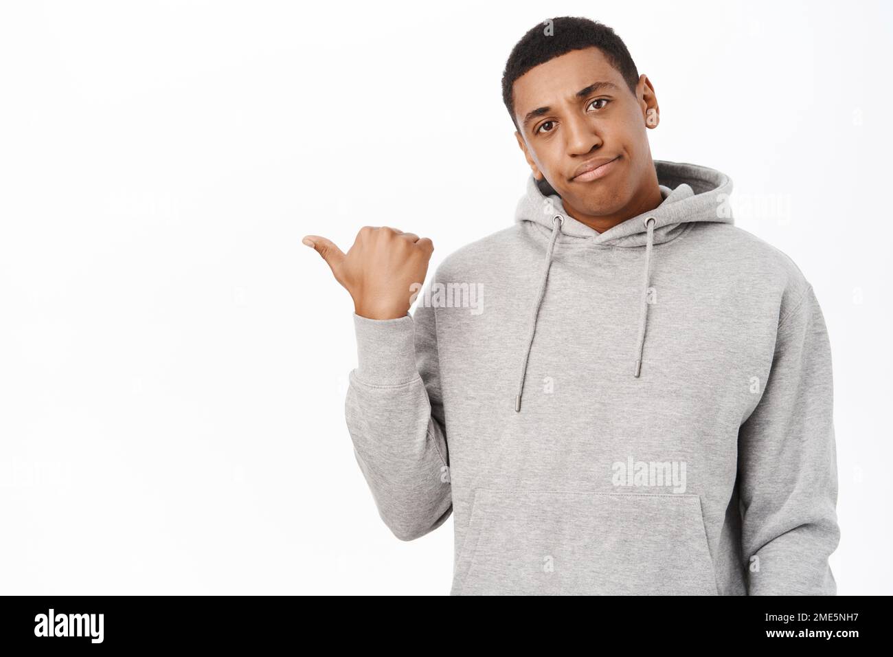 Annoyed african american man pointing finger left at copy space ...