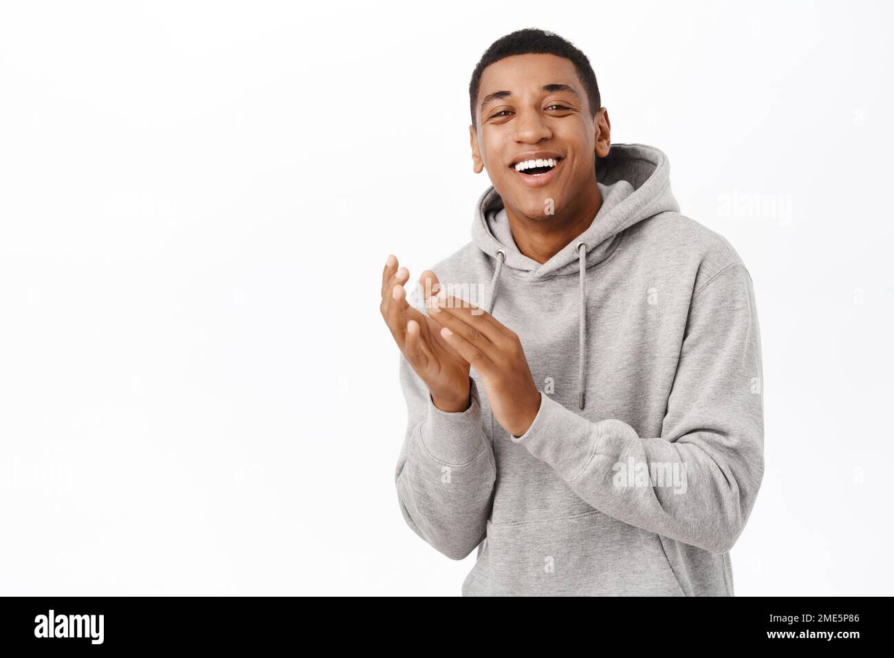 Happy smiling african american guy clap his hands, applause and praise ...