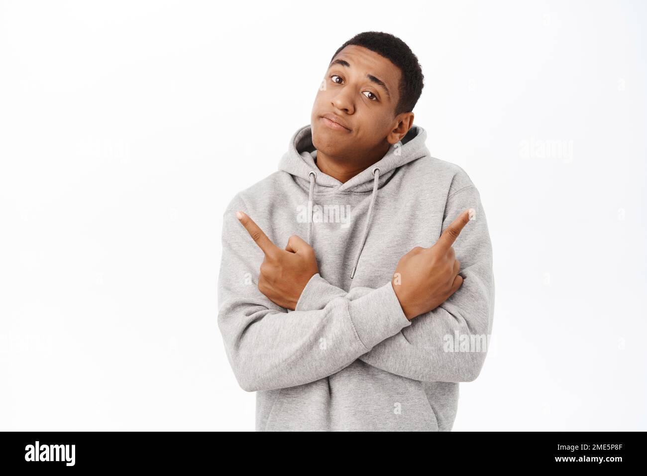 Portrait of african american guy making decision with confused face ...