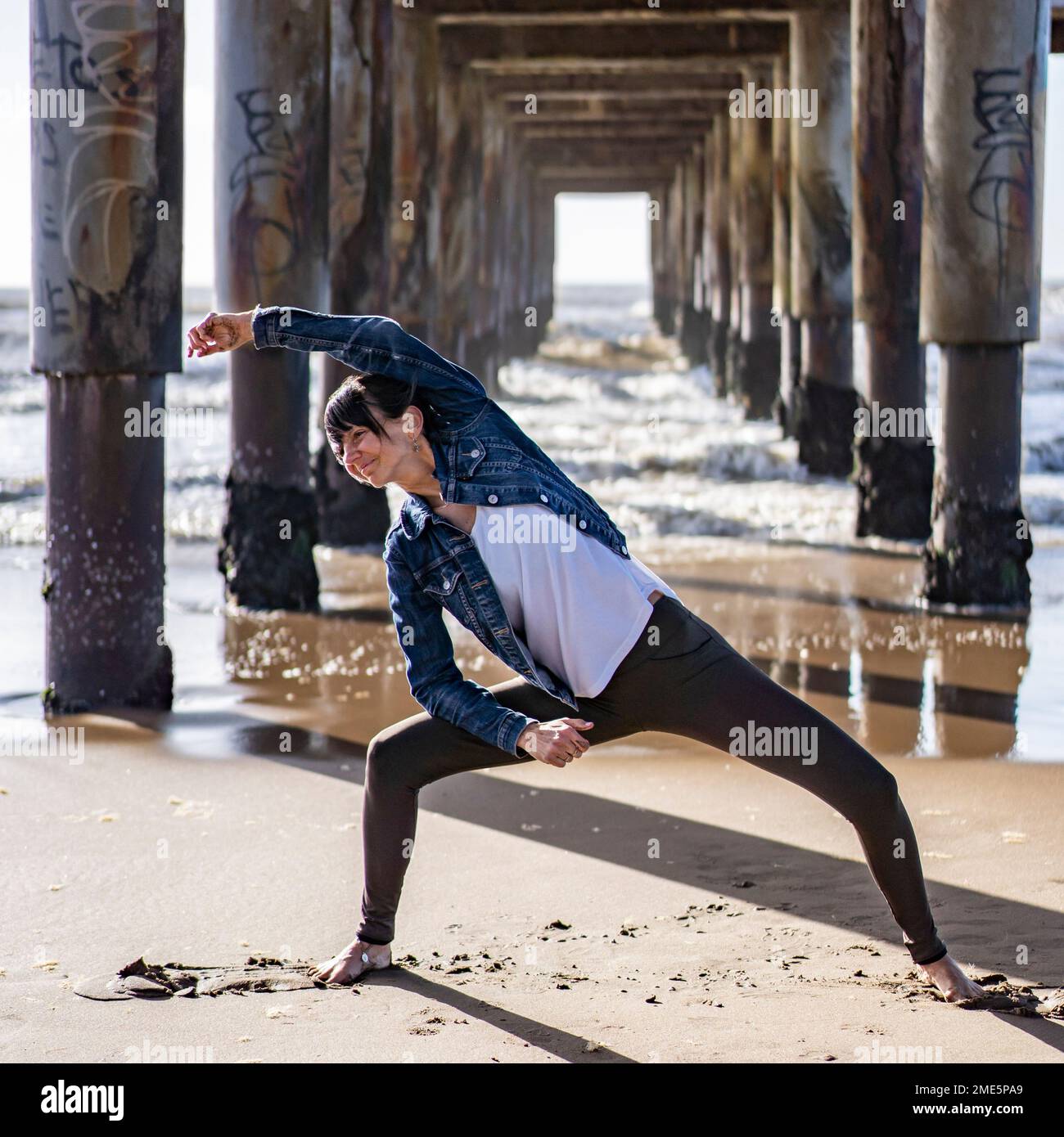 A woman doing stretching exercises outdoors Stock Photo - Alamy