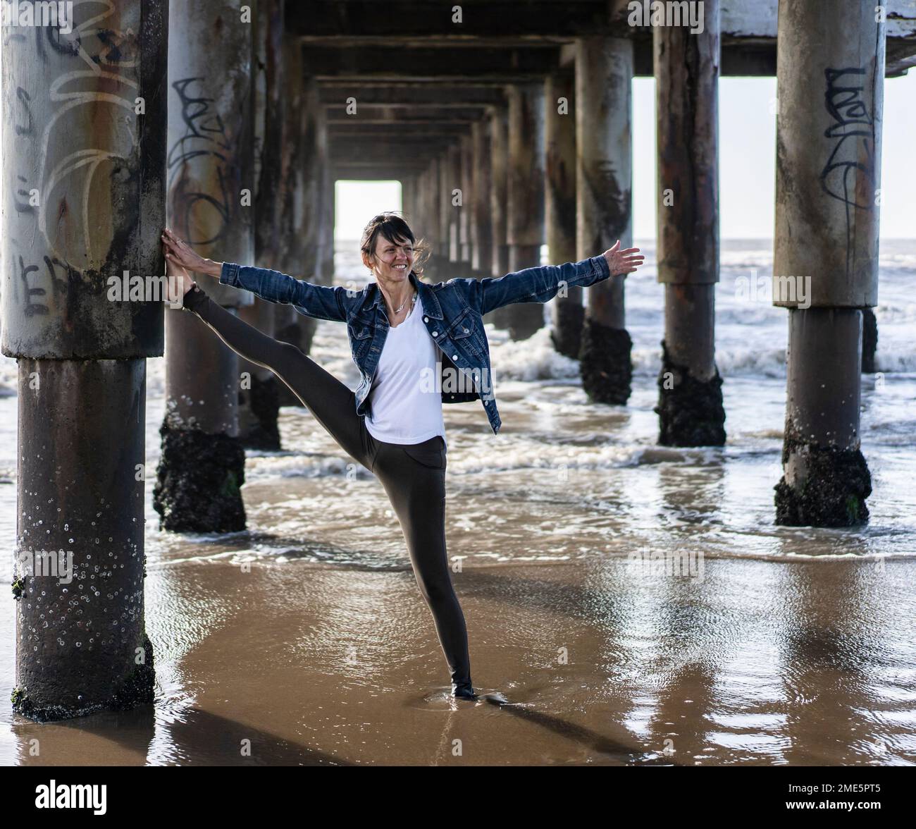 Happy woman doing stretching exercises outdoors Stock Photo - Alamy