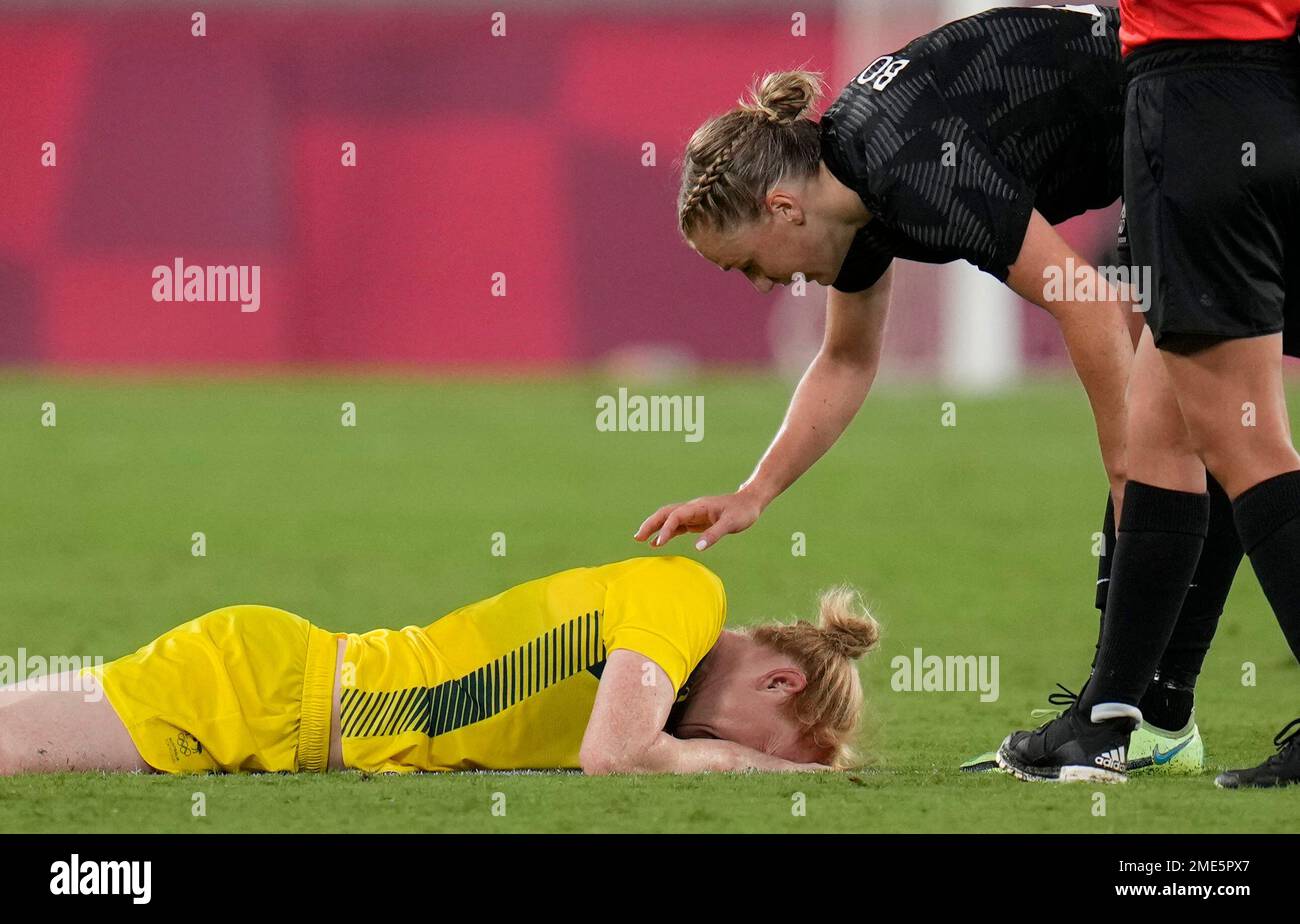 New Zealand's CJ Bott, right, touches Australia's Clare Polkinghorne ...