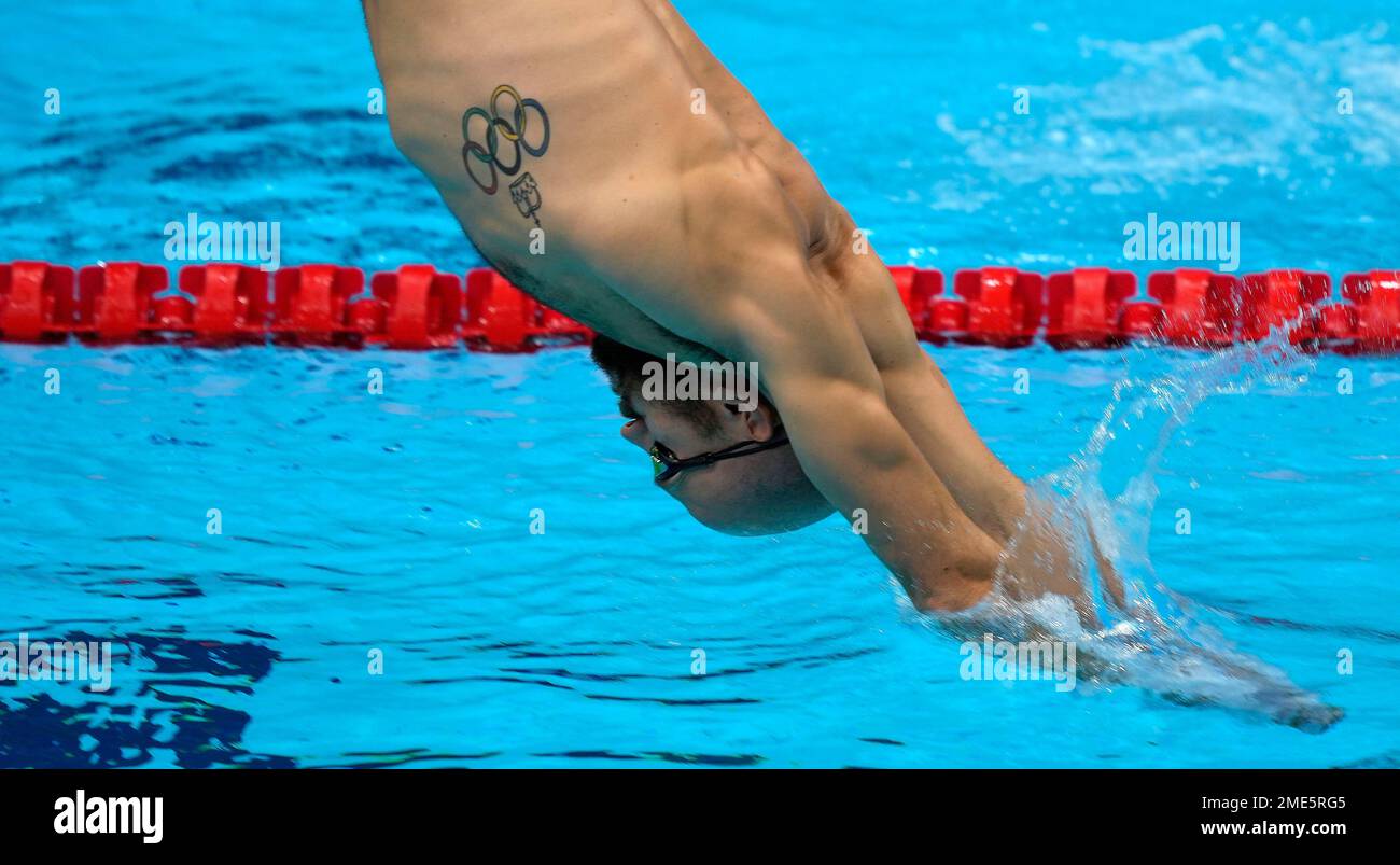 A swimmer with an Olympic tattoo exercises during a swimming training ...