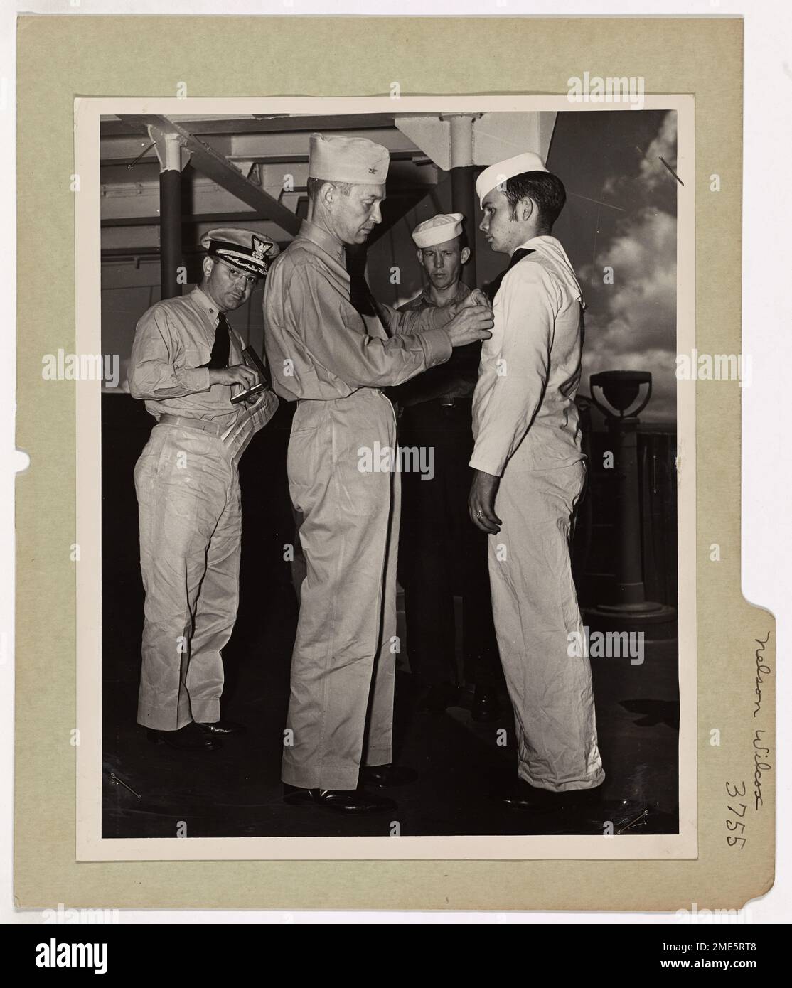 Captain Charles Dean of the U.S. Coast Guard awards the Purple Heart to ...