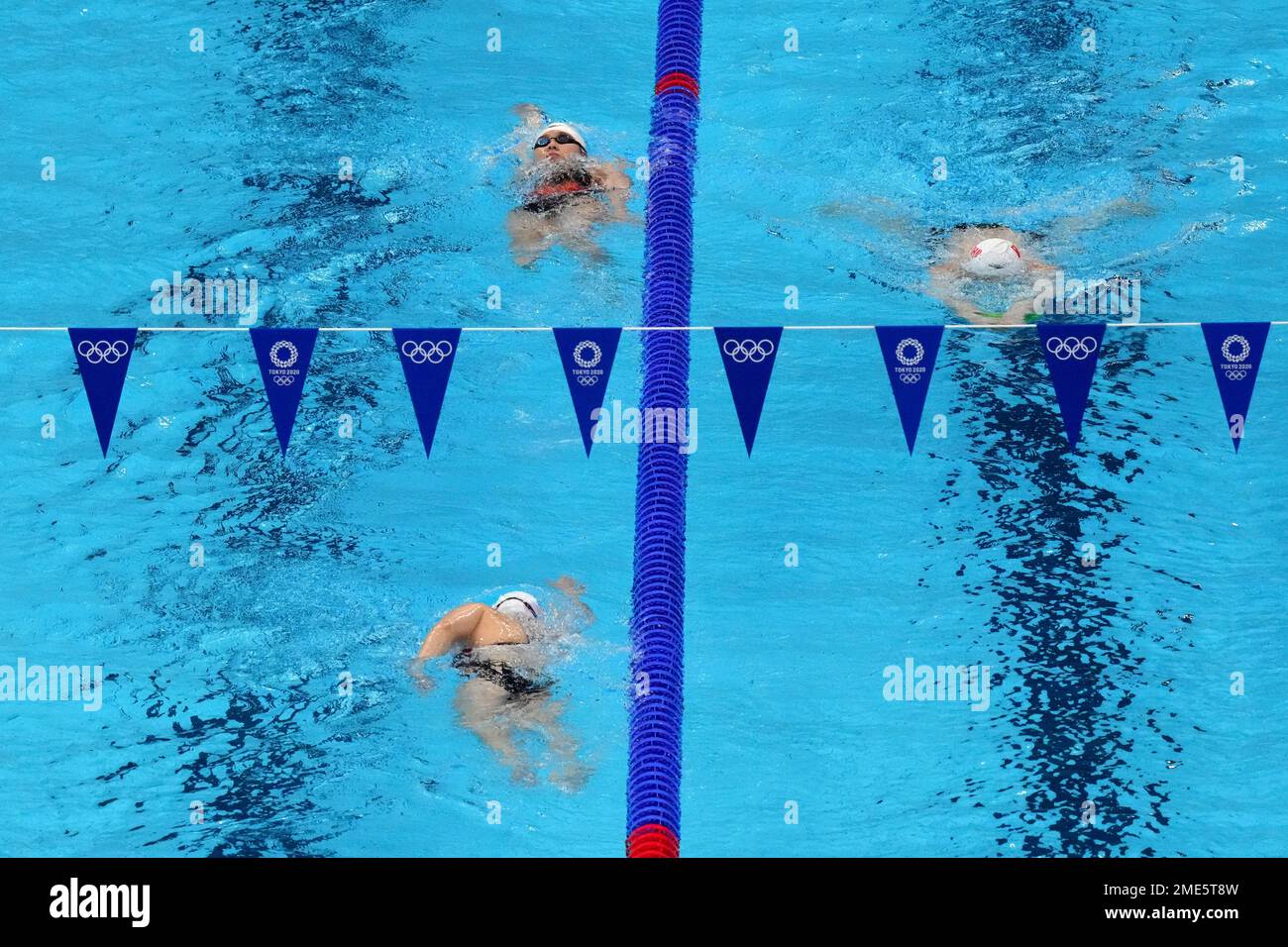 Athletes exercise during a swimming training session at the Tokyo ...