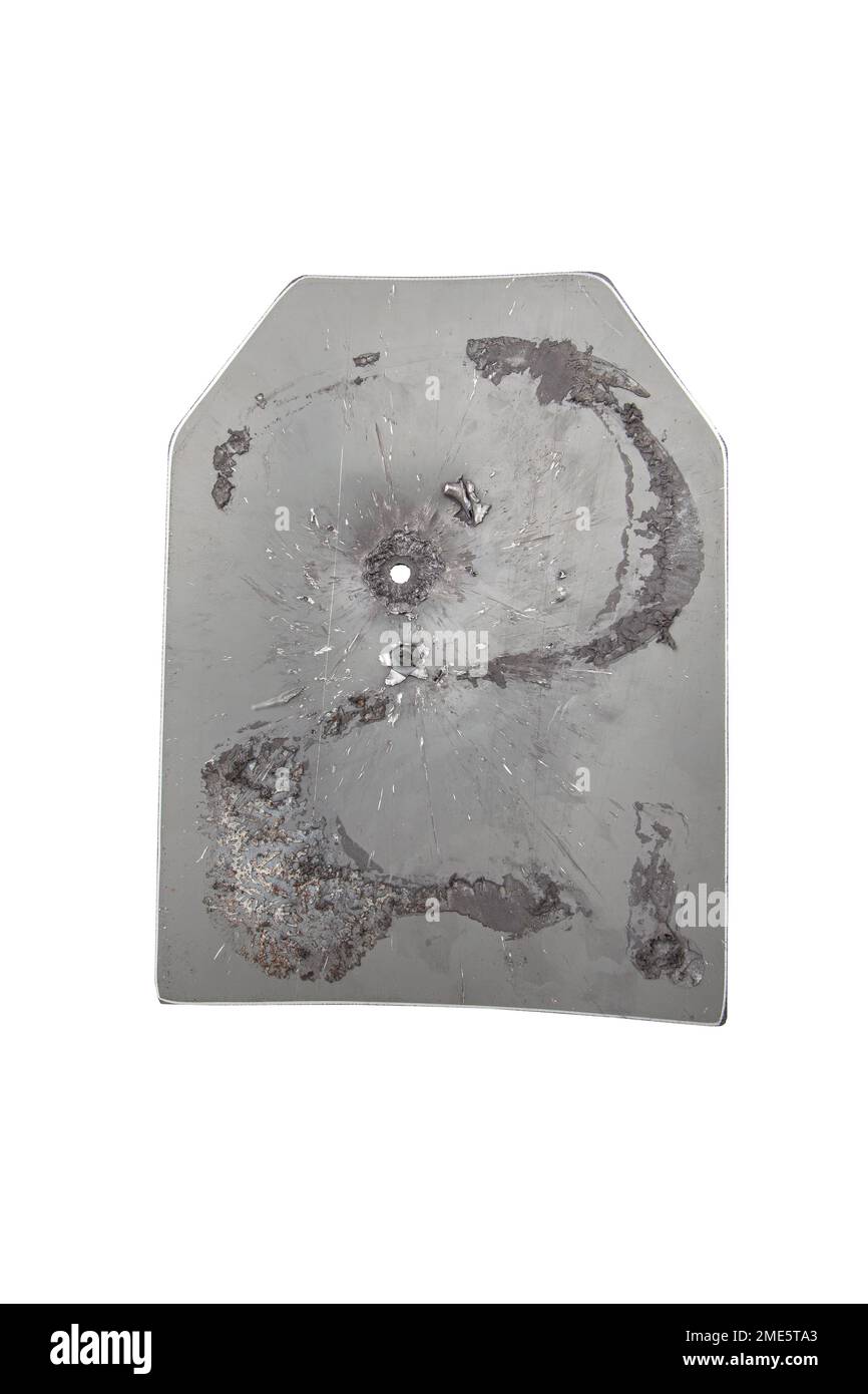 The metal plate of the bulletproof vest pierced by a bullet. Isolate on ...