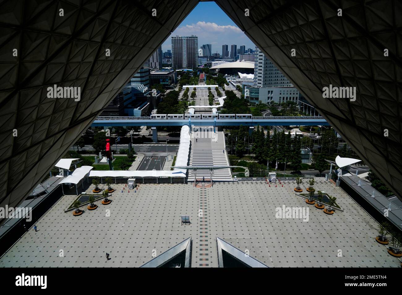 People walk outside the Main Press Center at the 2020 Summer Olympics ...