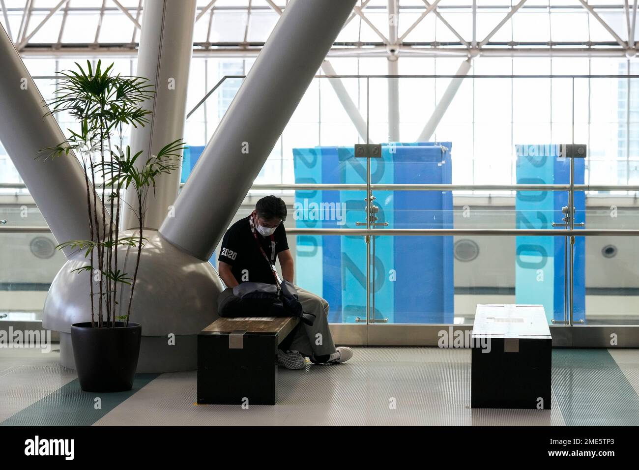 A man sits at the 2020 Summer Olympics, Wednesday, July 21, 2021, in ...