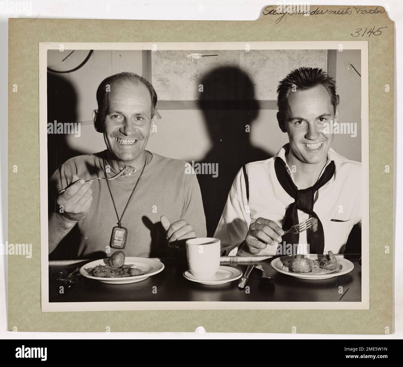 Coast Guardsman Paul M. Gratz, Jr. reunites with his father in a mid ...