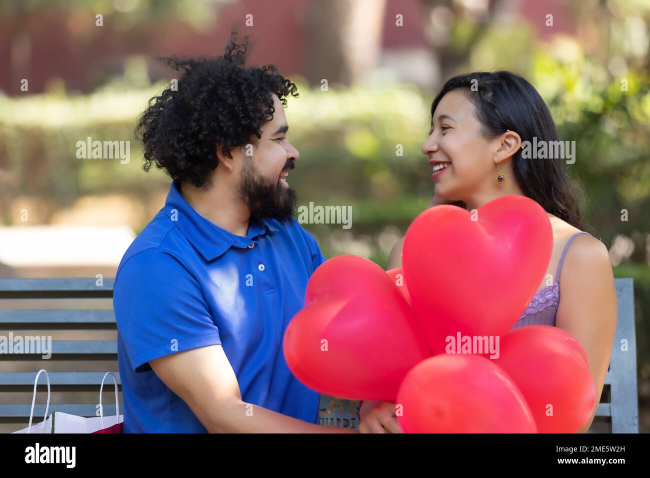 mexican young latin couple laughing and talking on valentine's day ...