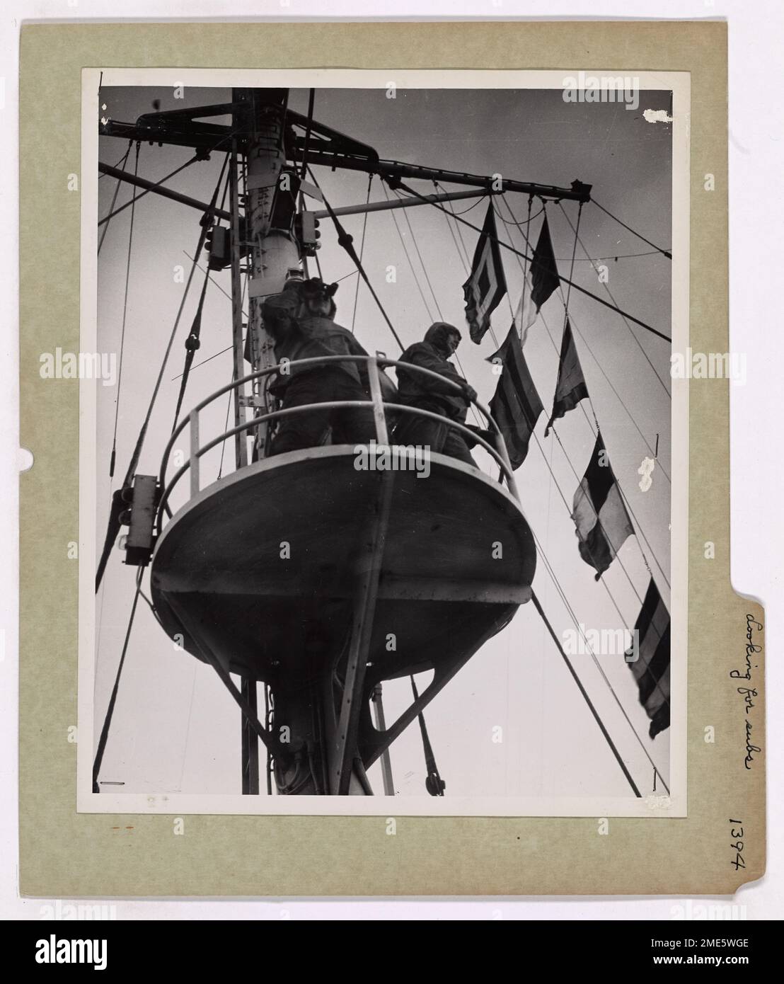 Two Coast Guardsmen keep a lookout for submarines from their ship's ...