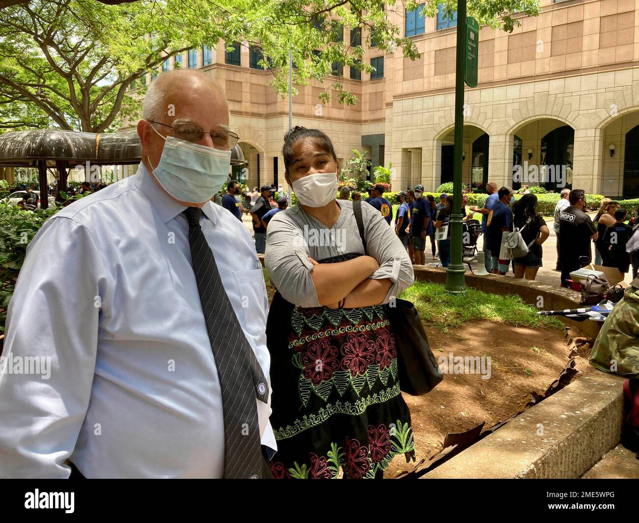 Attorney Eric Seitz and his client Yovita Sykap wait to enter a ...