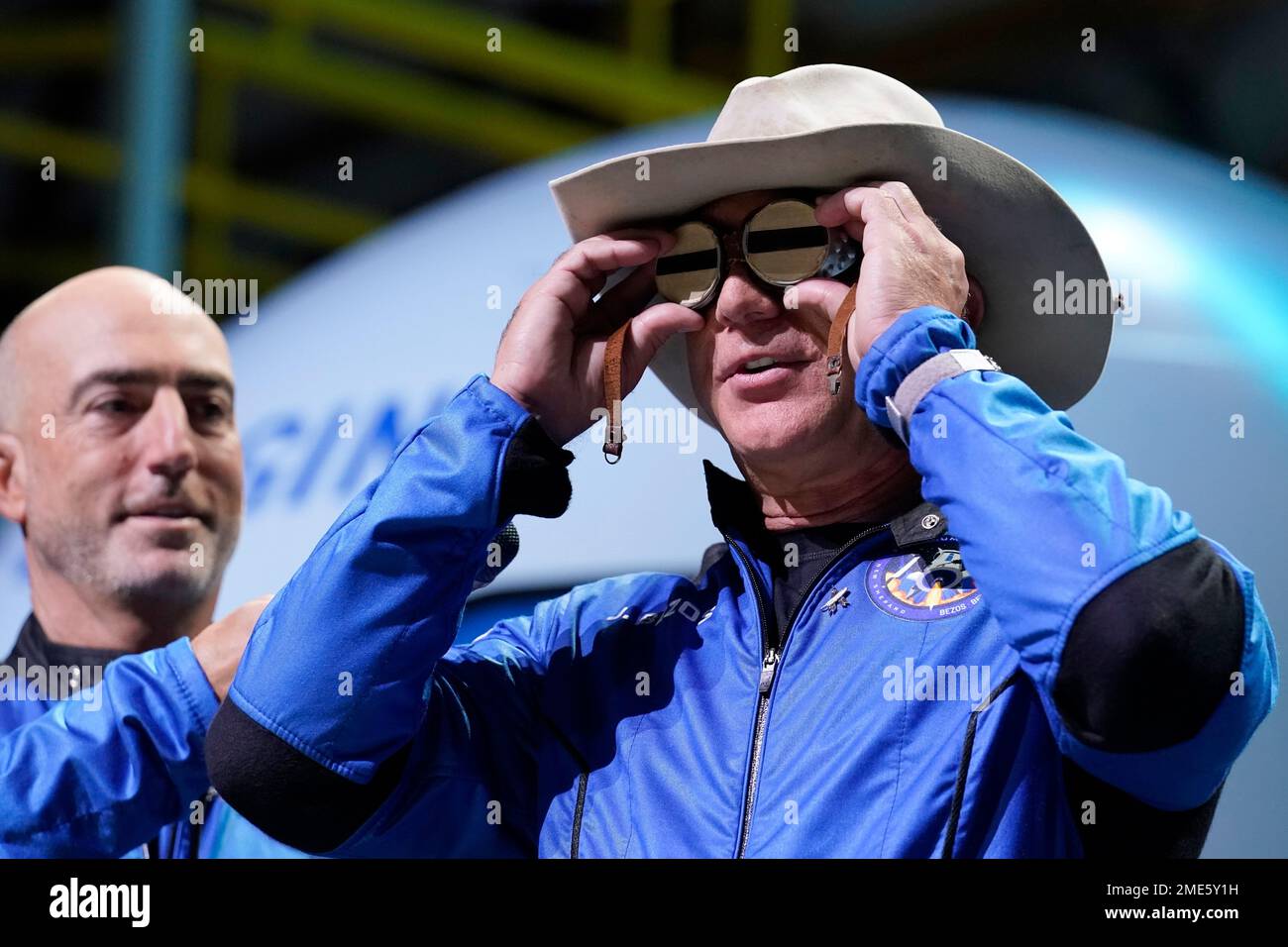 Mark Bezos, left, looks on as Jeff Bezos, founder of Amazon and space ...