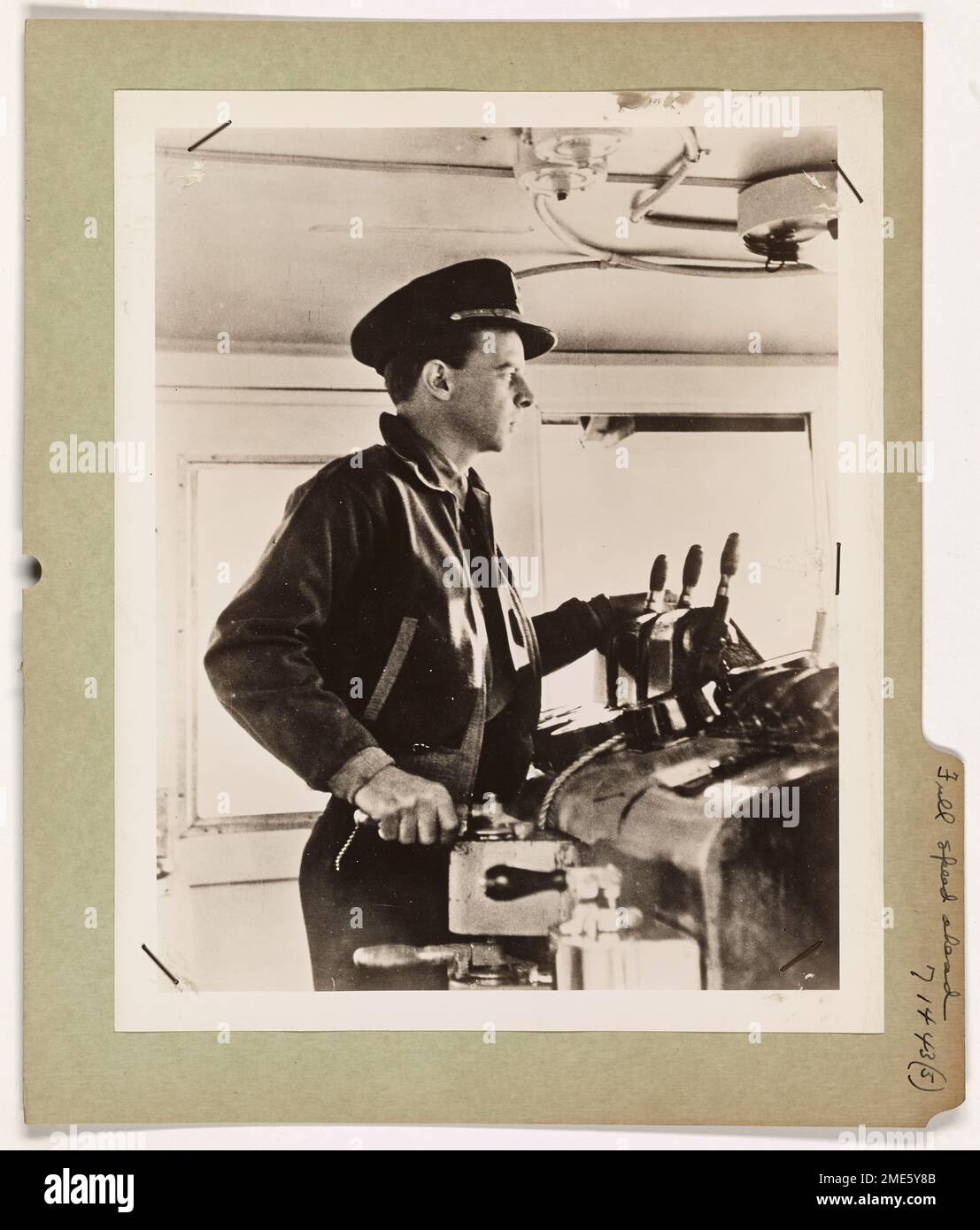 A Coast Guard officer steers an LCI (Landing Craft Infantry) during a ...