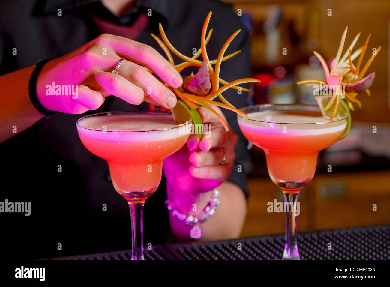 young woman bartender makes a cocktail with face mask Stock Photo - Alamy