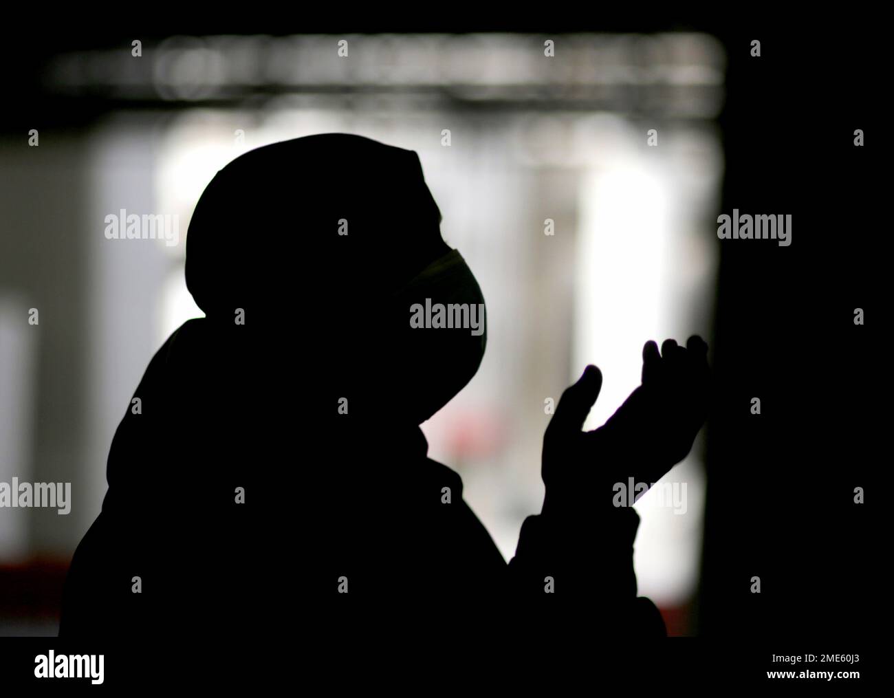 A Muslim pilgrim prays during symbolic stoning of the devil ritual ...