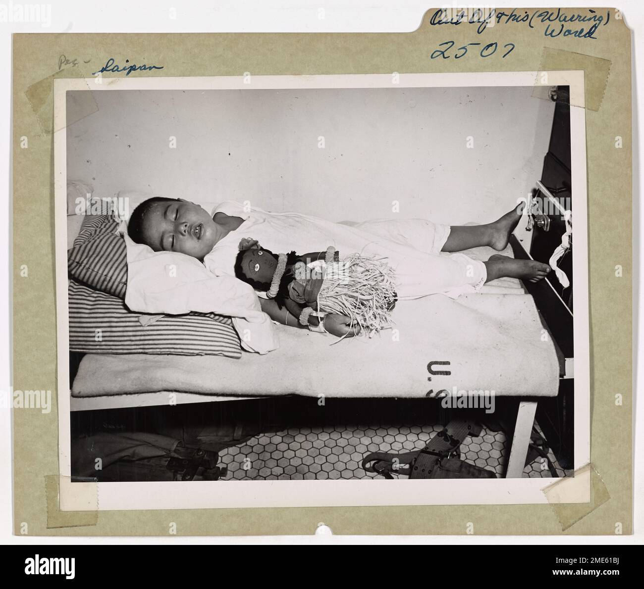 A Japanese child finds refuge aboard a Coast Guard-manned assault transport off Saipan, escaping ...