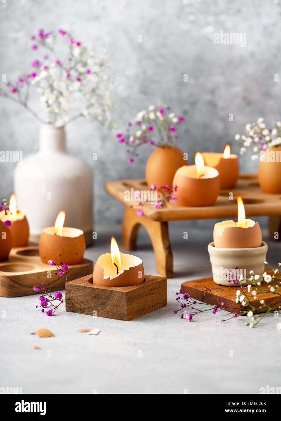 Handmade burning eggshell candles and egg vases with white and pink ...