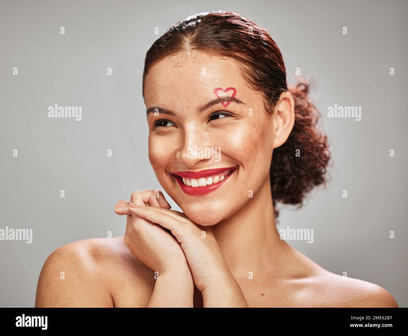 Beauty woman, makeup and heart face of a happy model in studio for ...