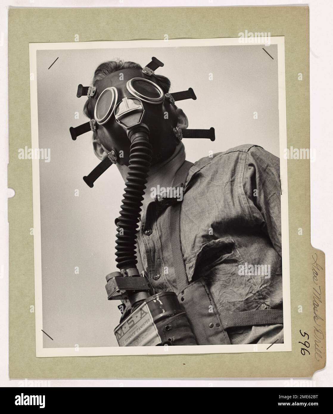 A Coast Guardsman is shown wearing a gas mask, part of routine military ...
