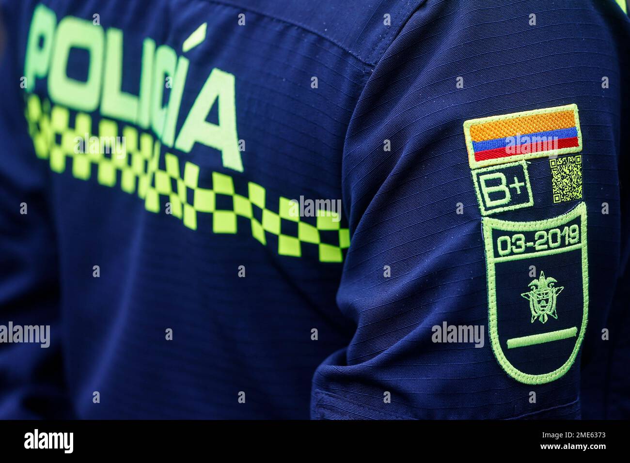 A National Police officer's uniform carries a QR code, blood type and ...