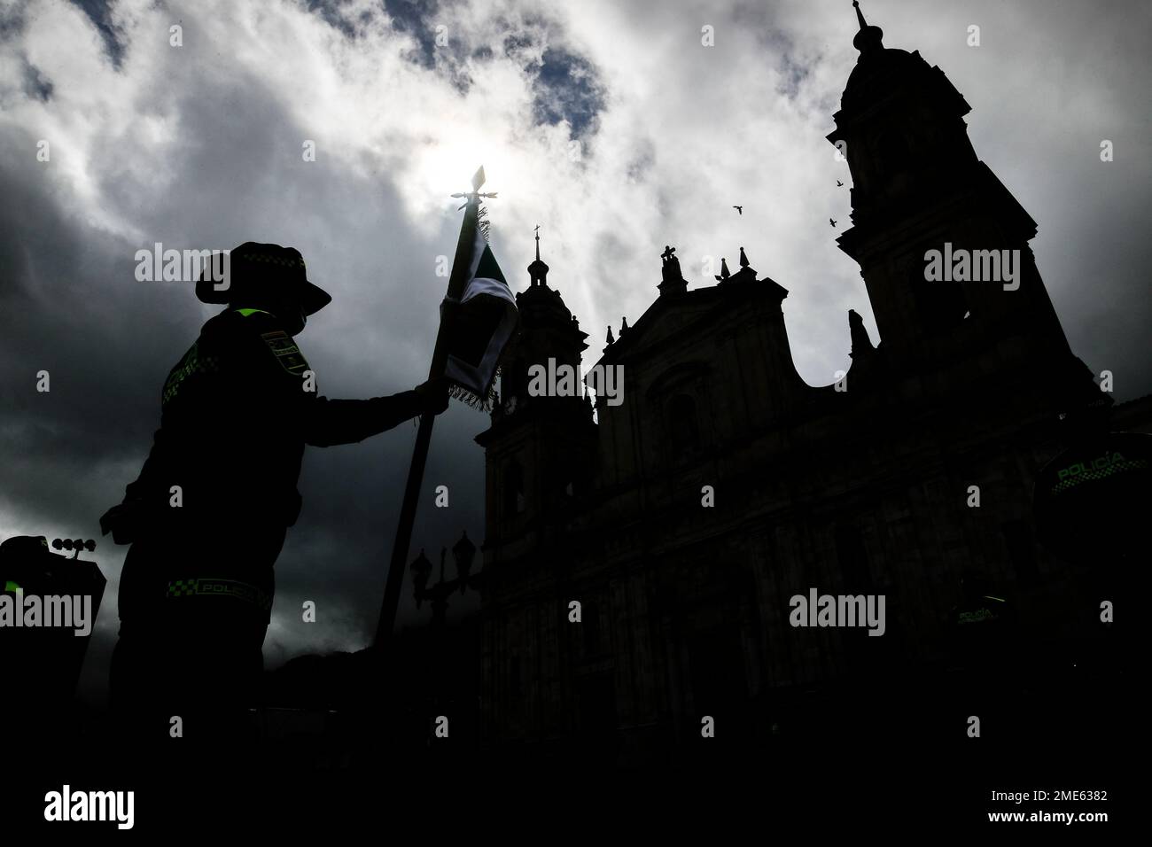 A National Police officer stands with a flag outside the Cathedral in ...
