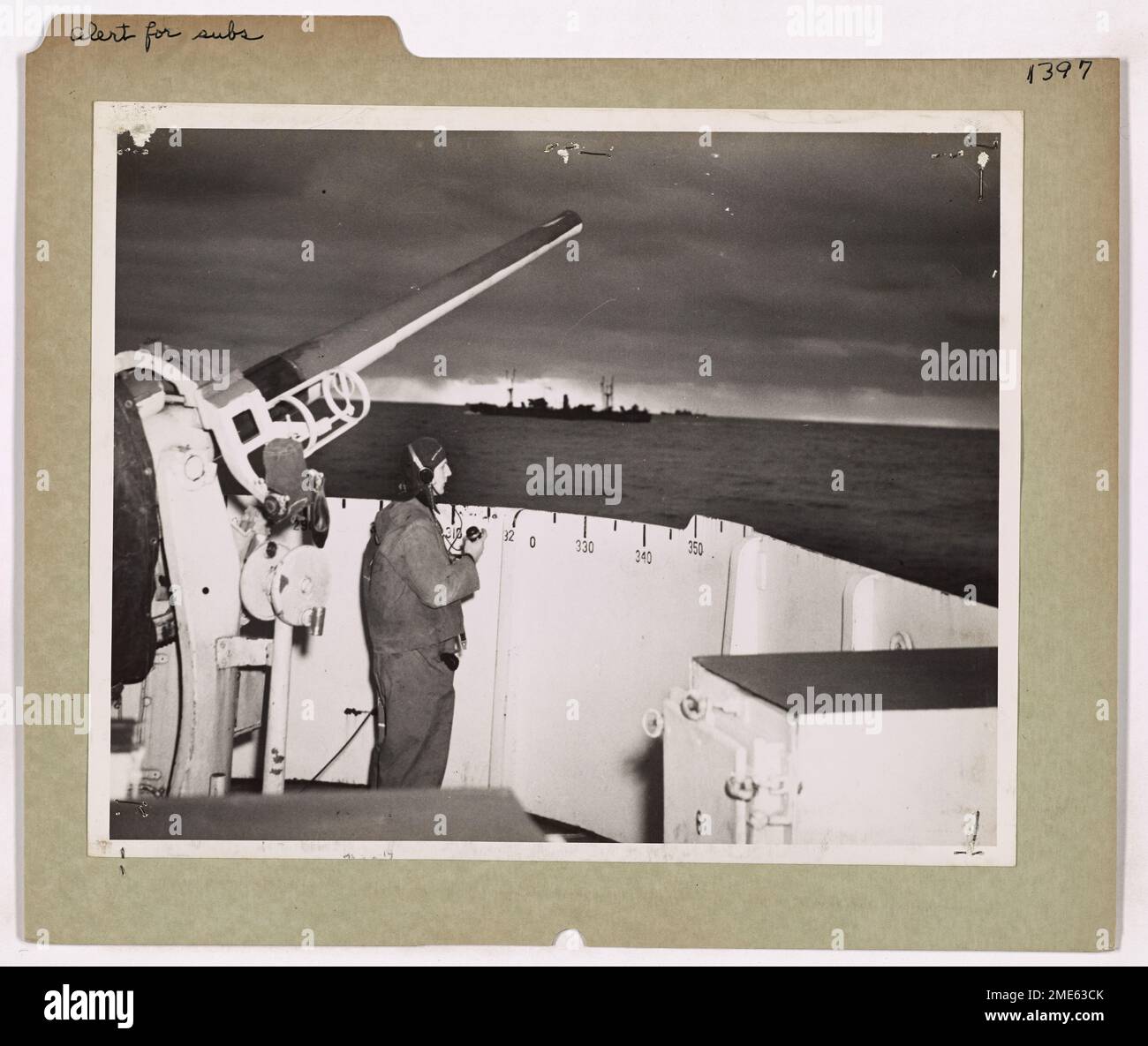 A Coast Guardsman stands on lookout duty, scanning the waters for enemy ...