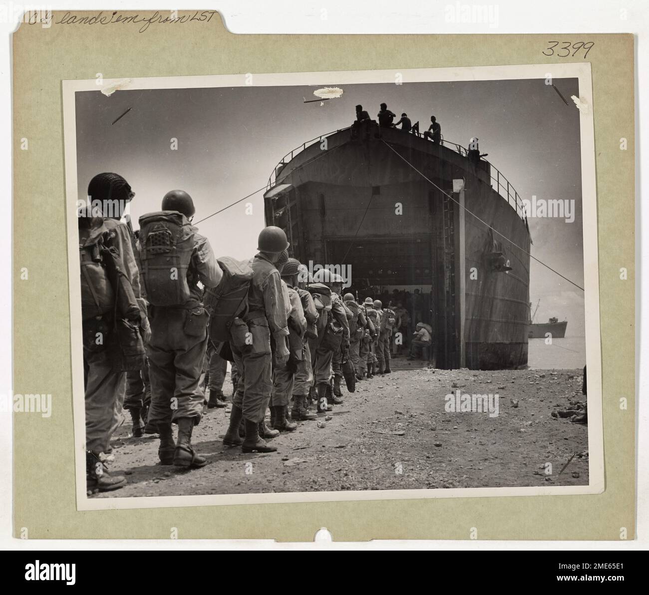A Coast Guard-manned LST (Landing Ship, Tank) opens its bow doors to ...