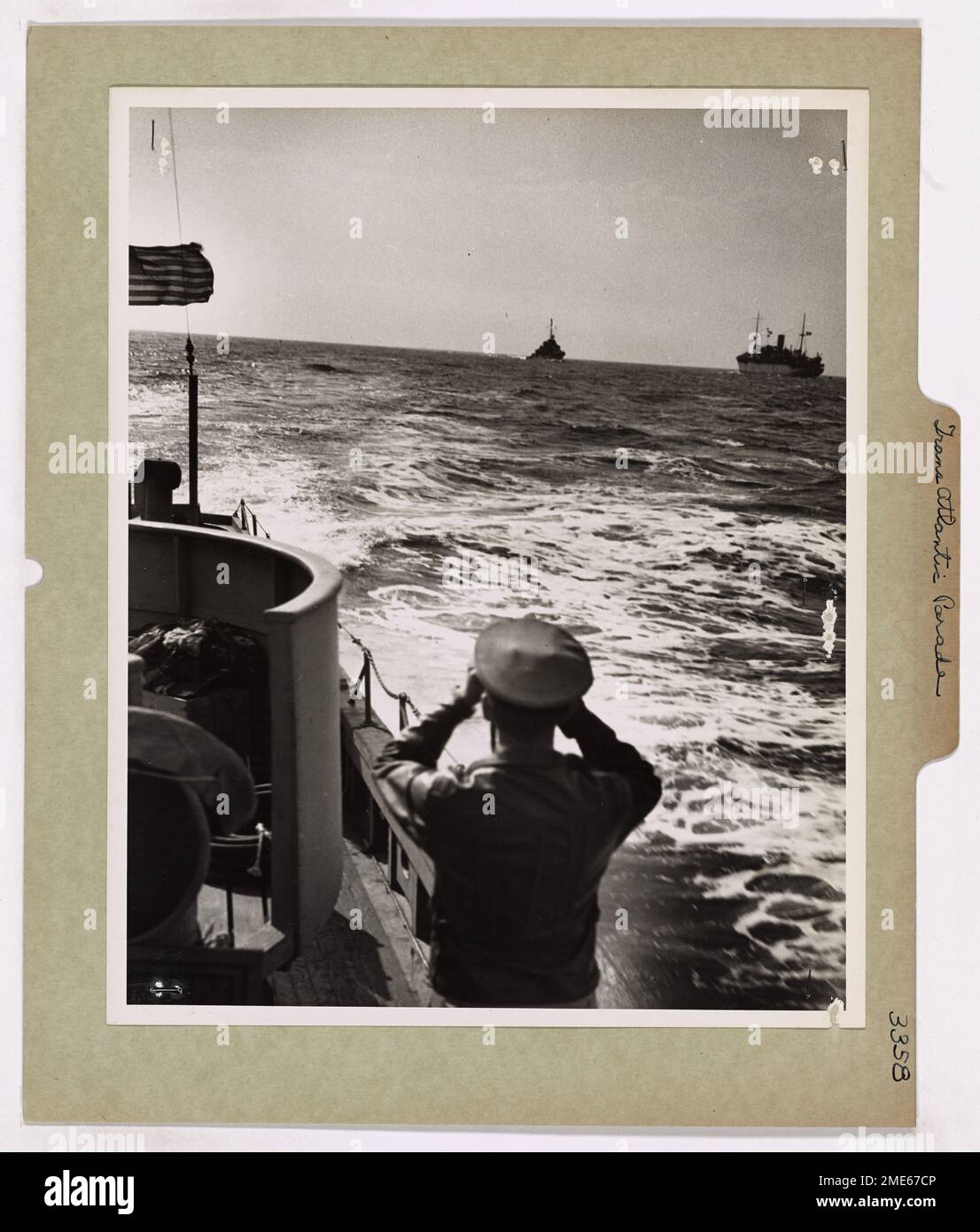 A convoy of troops and supplies, escorted by Coast Guard fighting ...