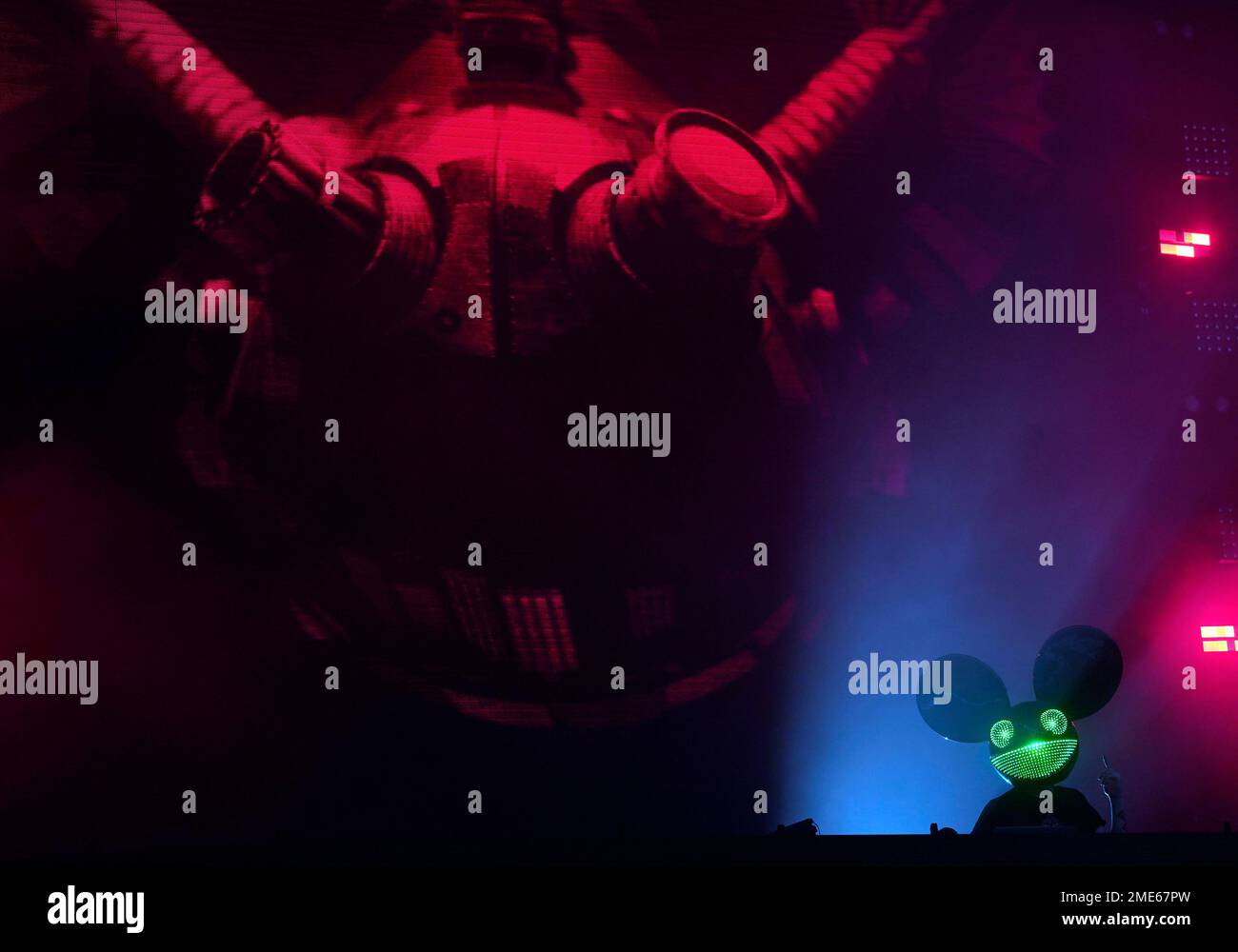 Electronic music producer Deadmau5, bottom right, performs in front of ...