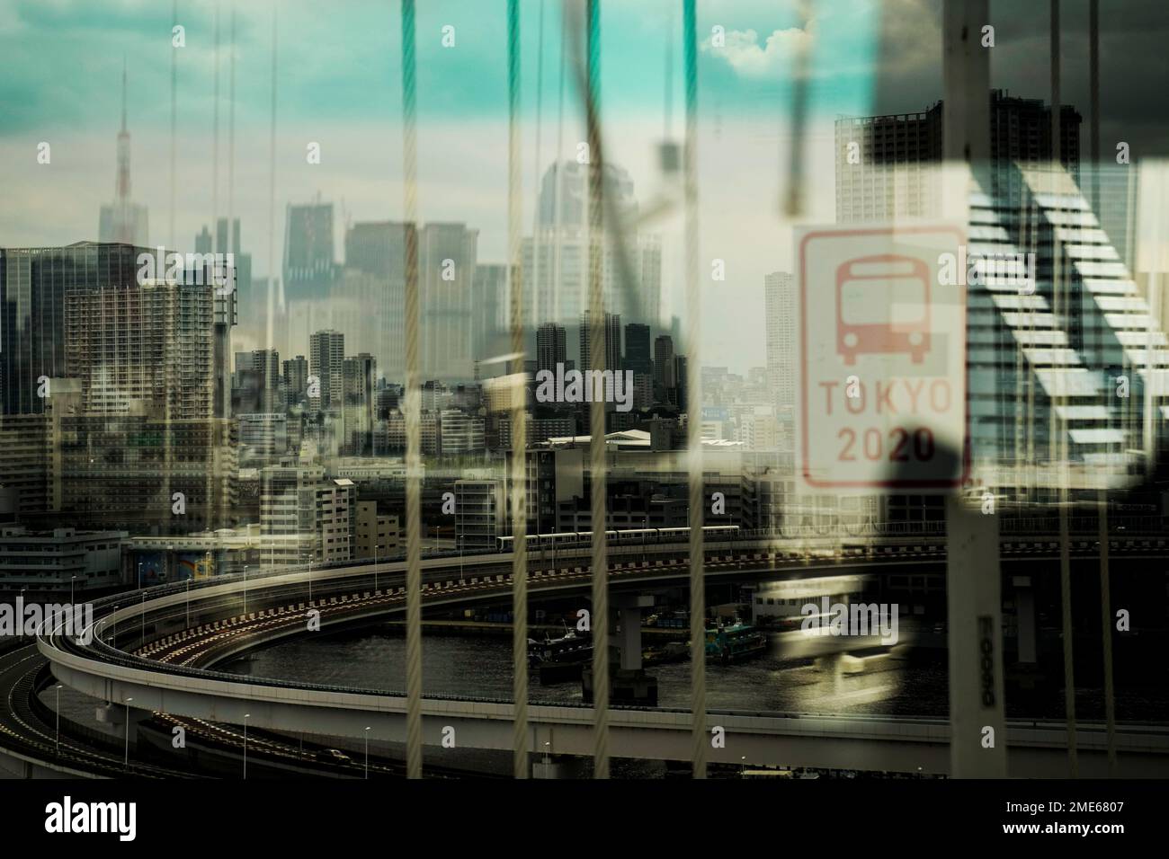 The skyline of Tokyo is seen through a bus window from the Rainbow ...