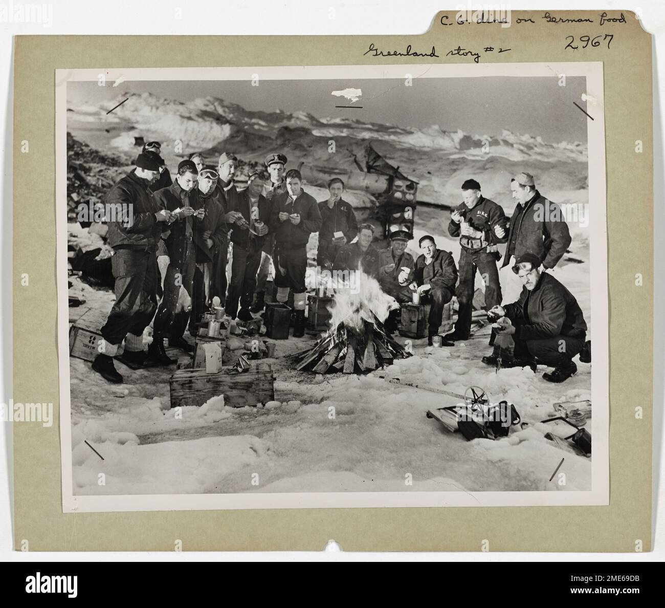 Coast Guardsmen dine on German canned goods at the site of an abandoned ...