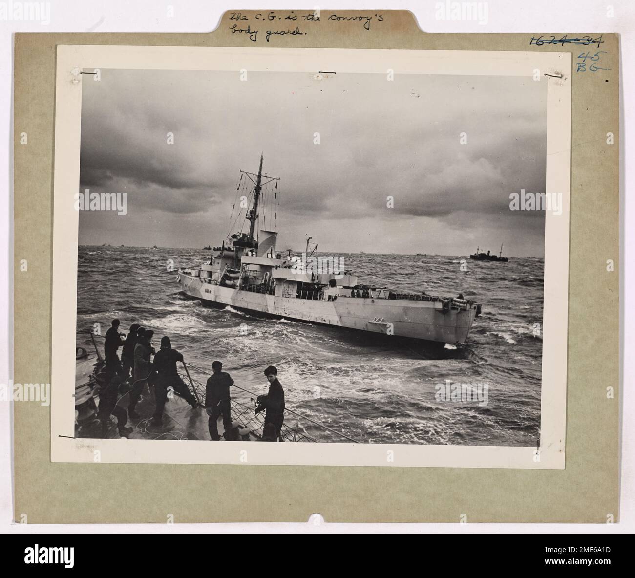A U.S. Coast Guard cutter is seen escorting and defending merchant ...