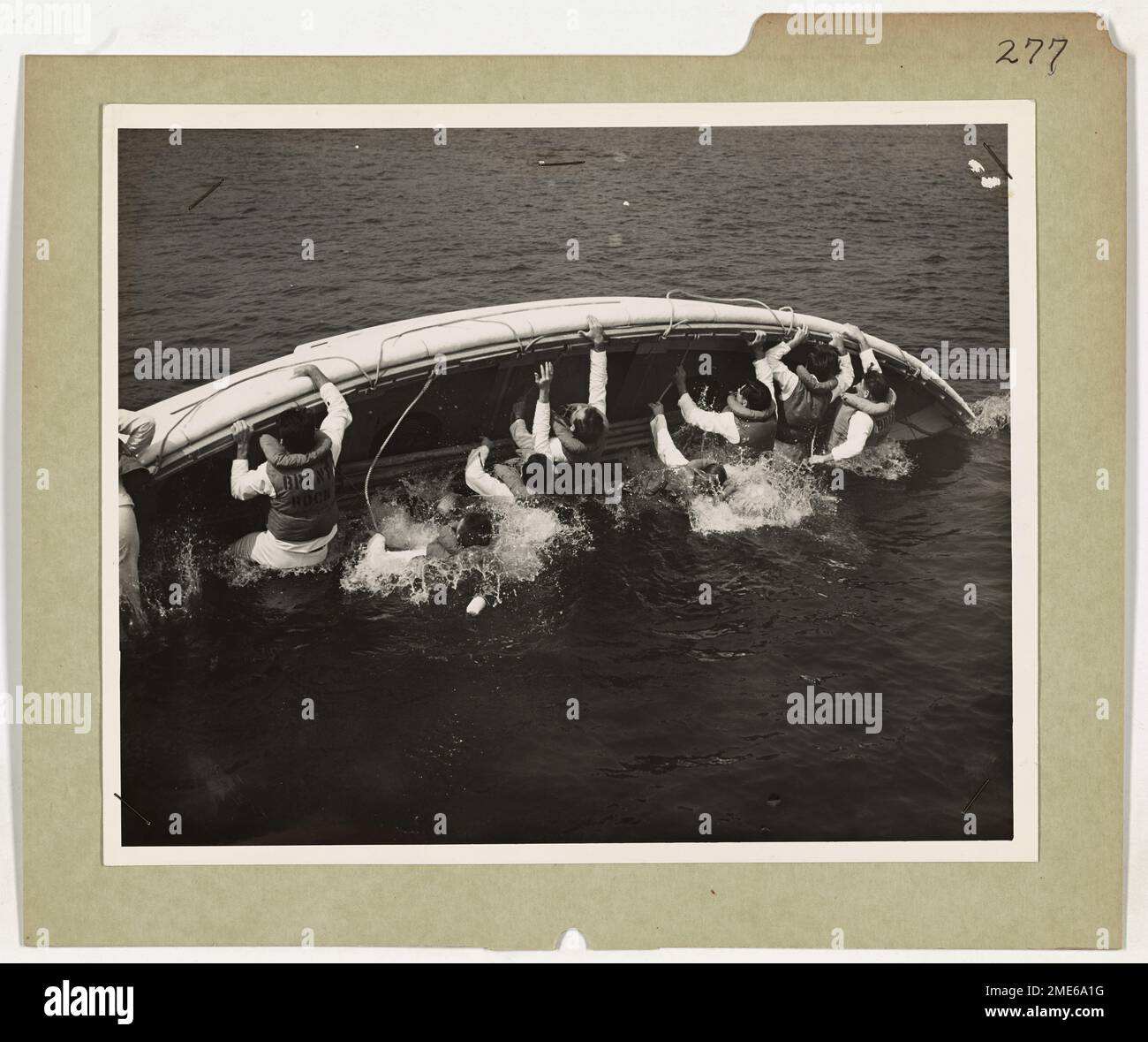 Coast Guardsmen are seen flipping a lifeboat during a training exercise ...