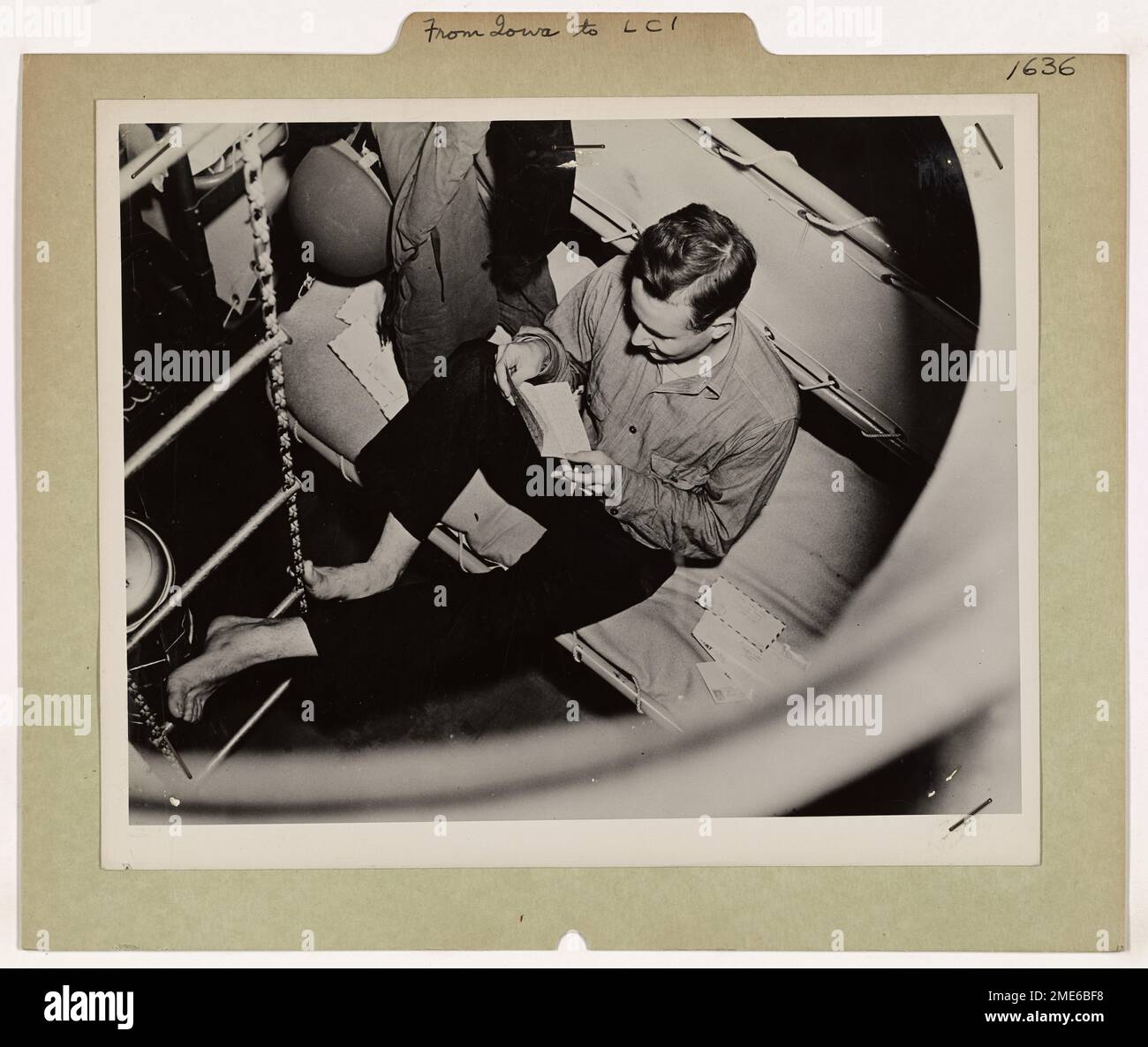 From Iowa to LCI. This image depicts Coast Guardsman Louis Hill reading ...